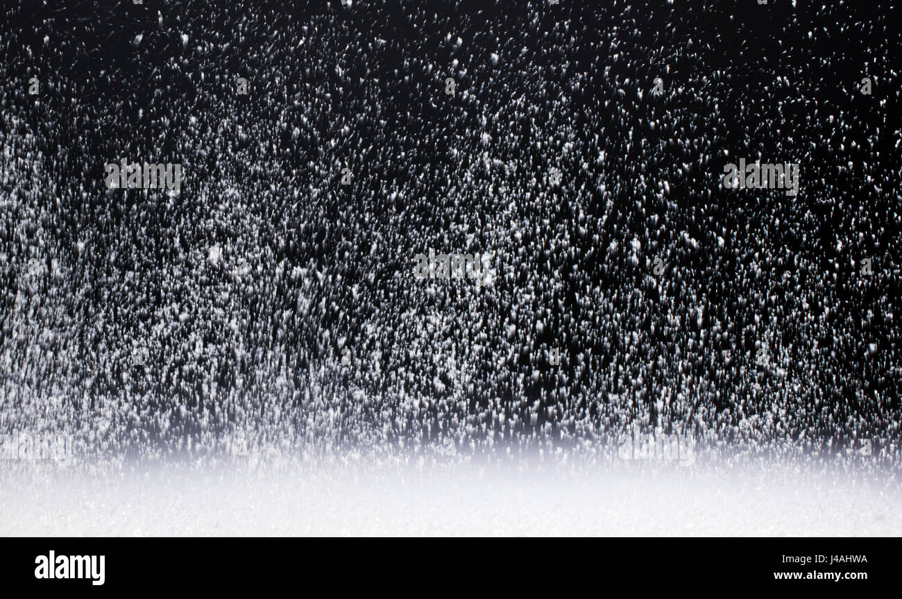 Artificial snow flakes floating in the air, photographed in a ...