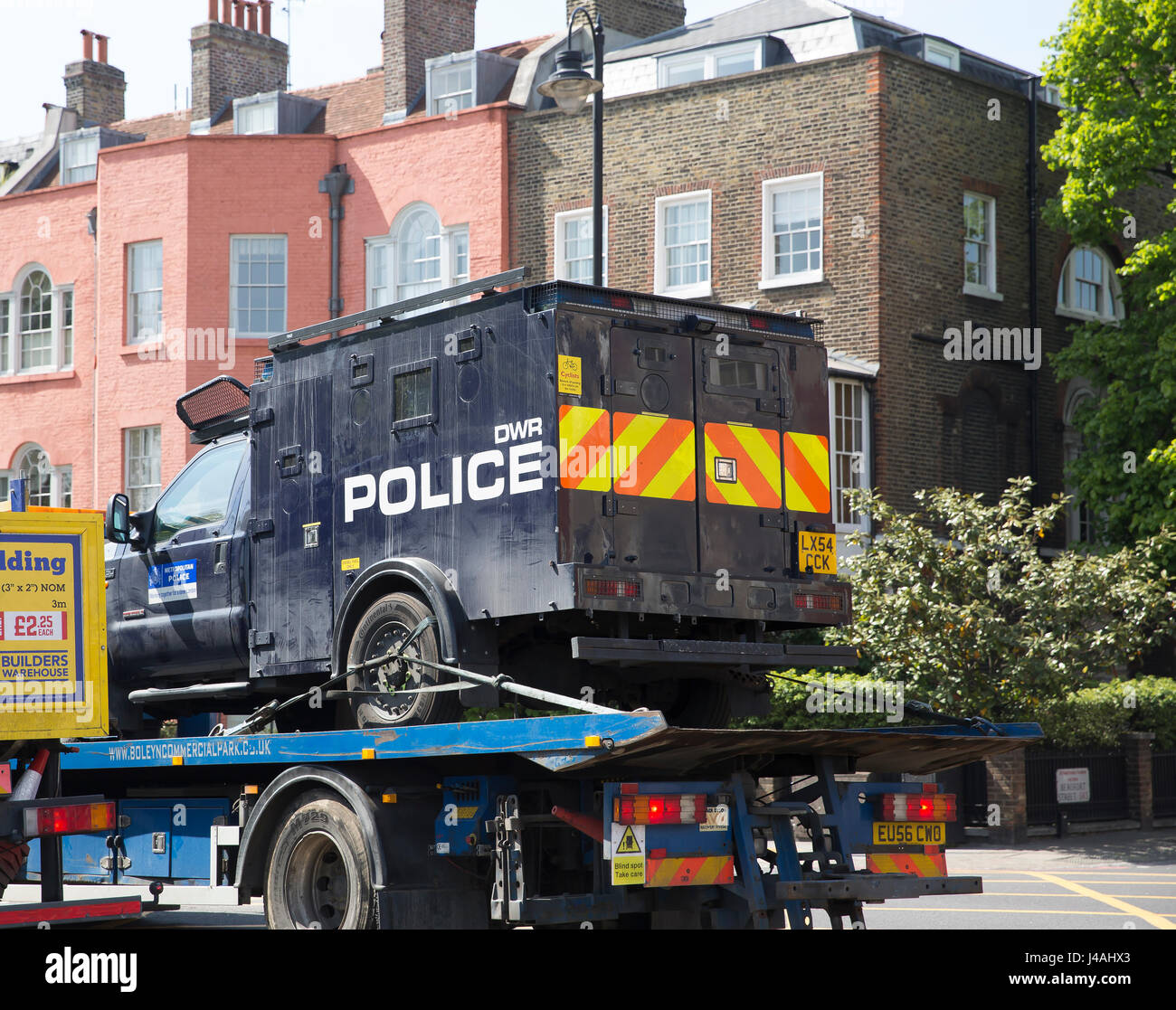 Police armoured vehicle on the back of a low loader truck in London ...