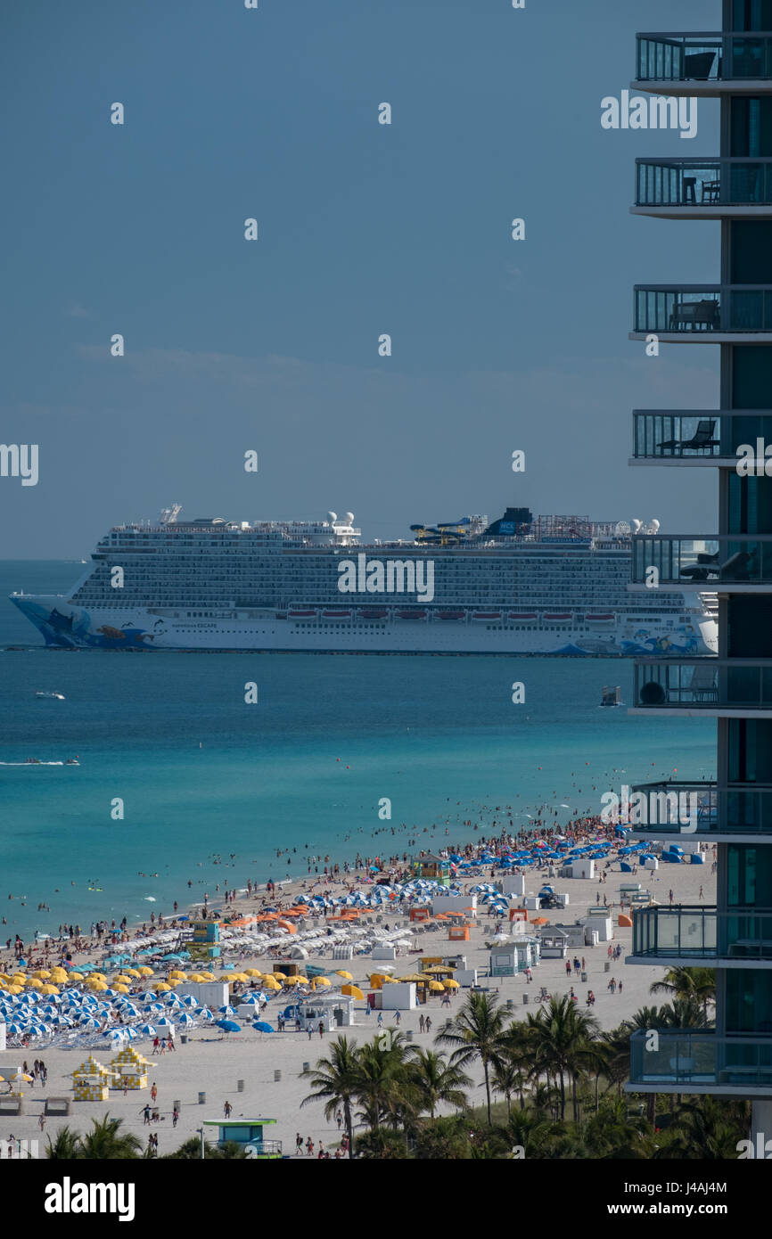 Cruise ship with a crowded beach and a building with balconies Stock ...