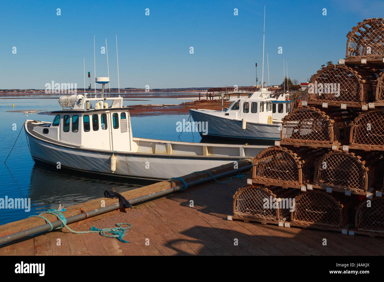 Commercial fishing boats at a wharf in rural Prince Edward Island ...