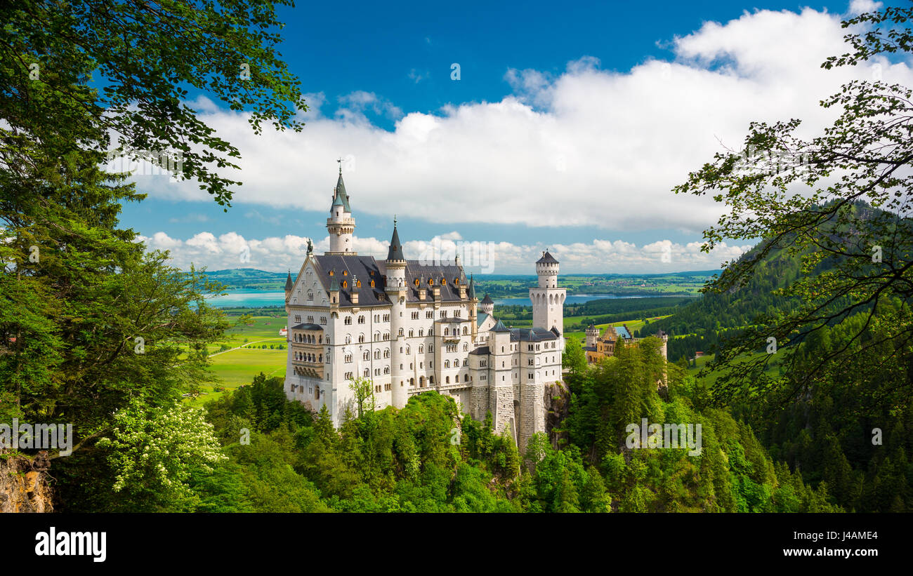Famous fairy tale Castle in Bavaria, Neuschwanstein, Germany, panoramic view with blue sky and ...