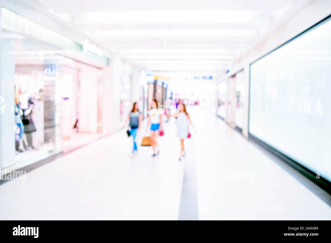 Women walking fast in shopping mall with bags Stock Photo - Alamy