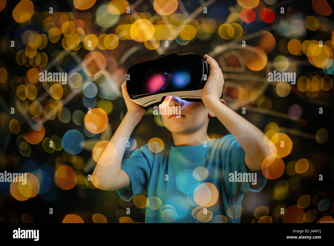 Child playing with a virtual reality headset. Young boy wearing and ...