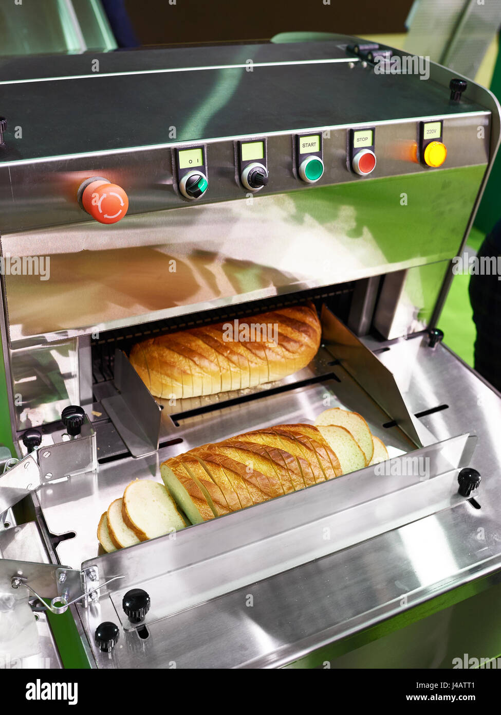 Big bread cutting machine closeup Stock Photo - Alamy