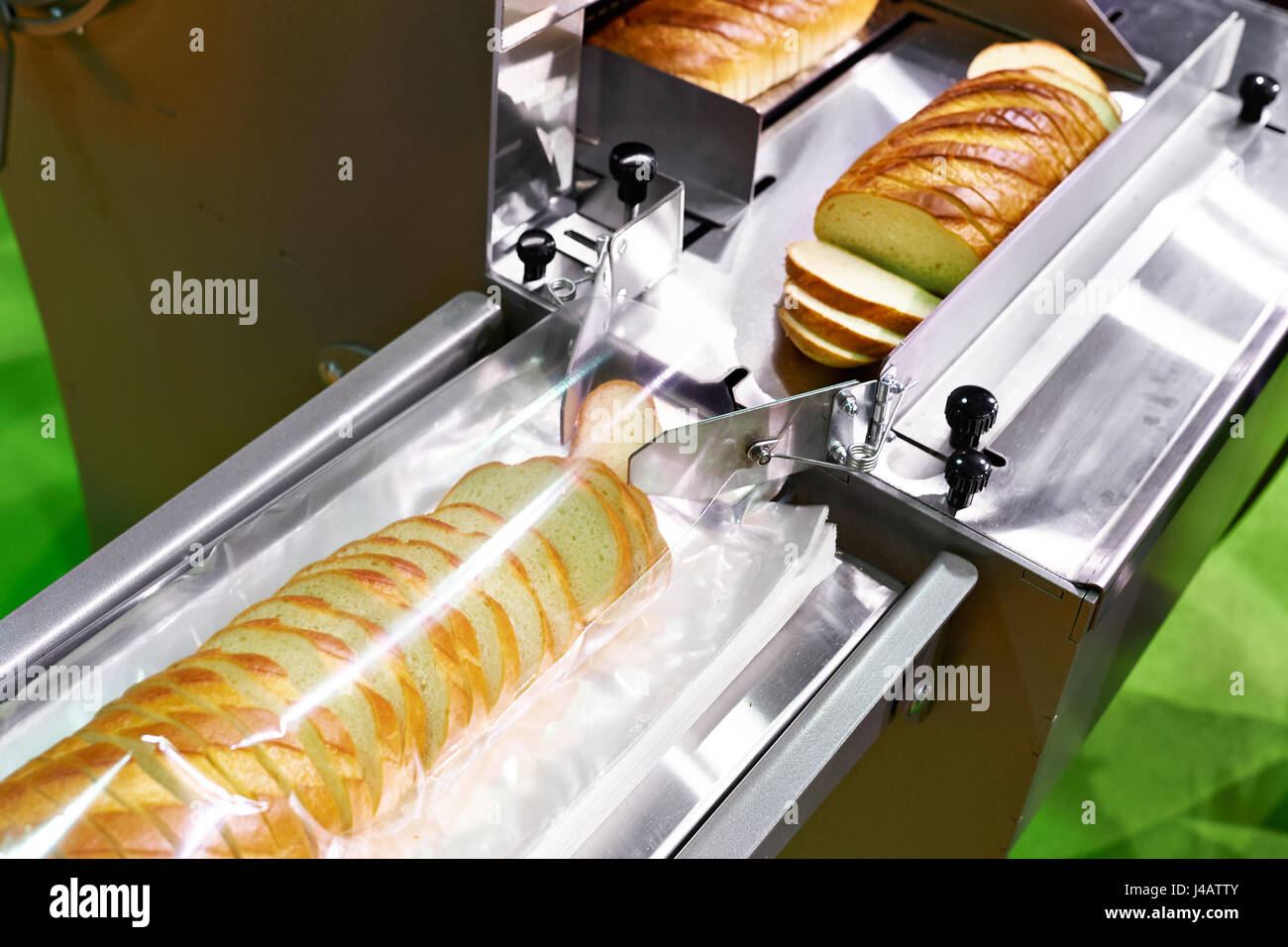 Big bread cutting machine closeup Stock Photo - Alamy
