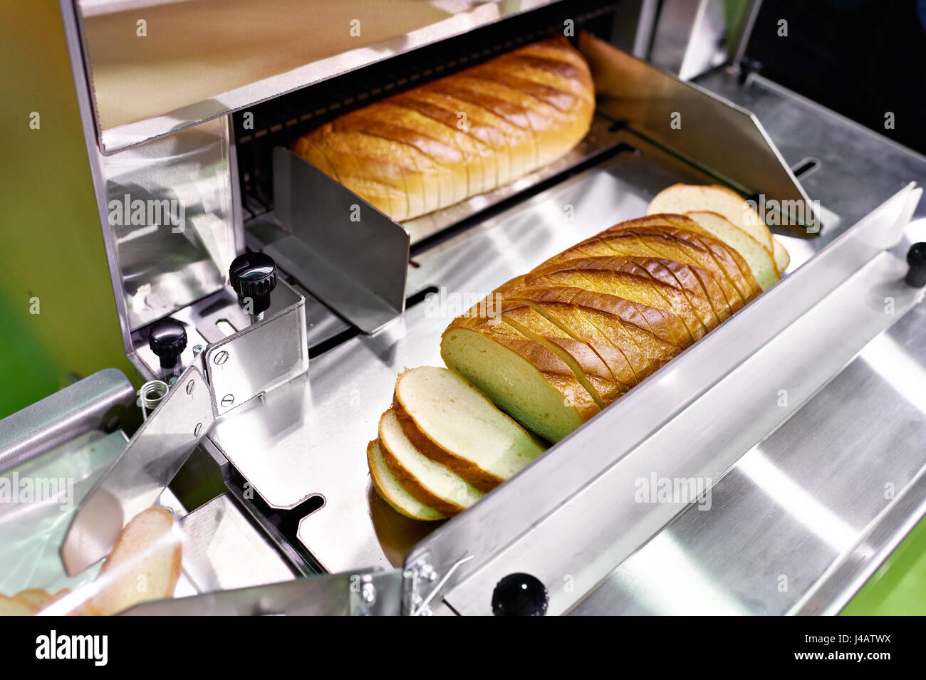 Big bread cutting machine closeup Stock Photo - Alamy