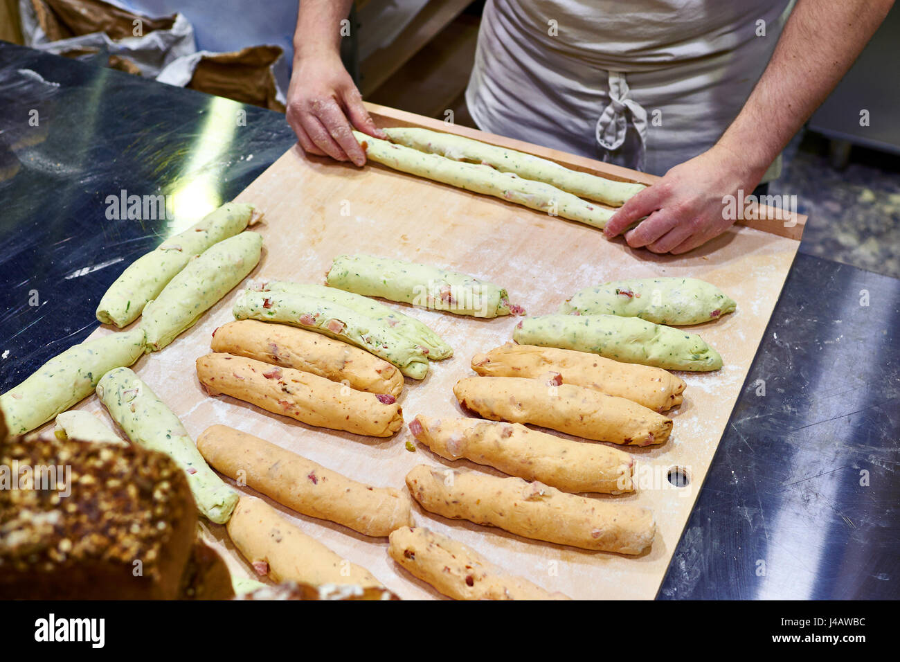 Roll out the dough before baking bread in a bakery Stock Photo - Alamy