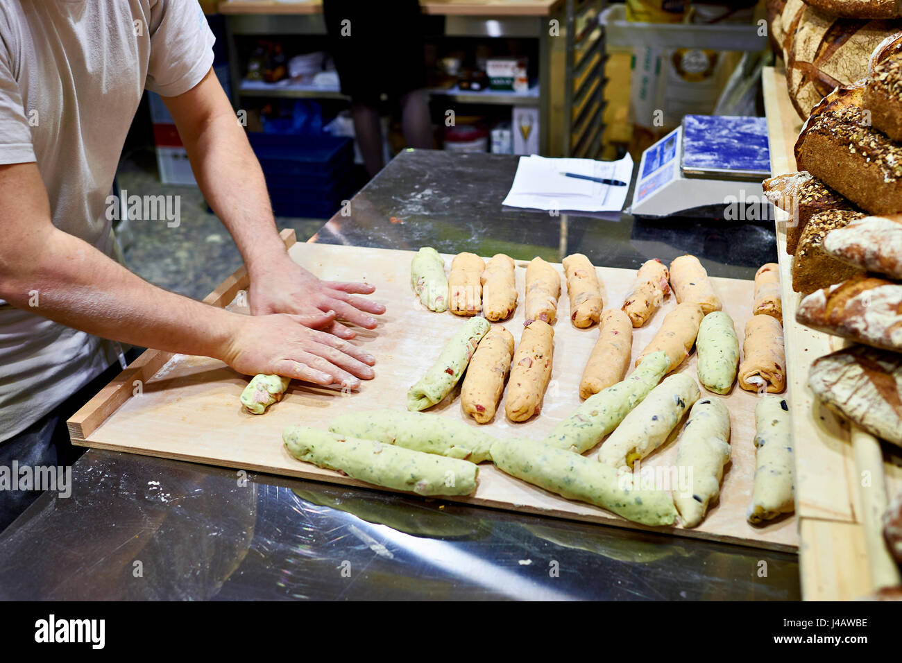 Roll out the dough before baking bread in a bakery Stock Photo - Alamy