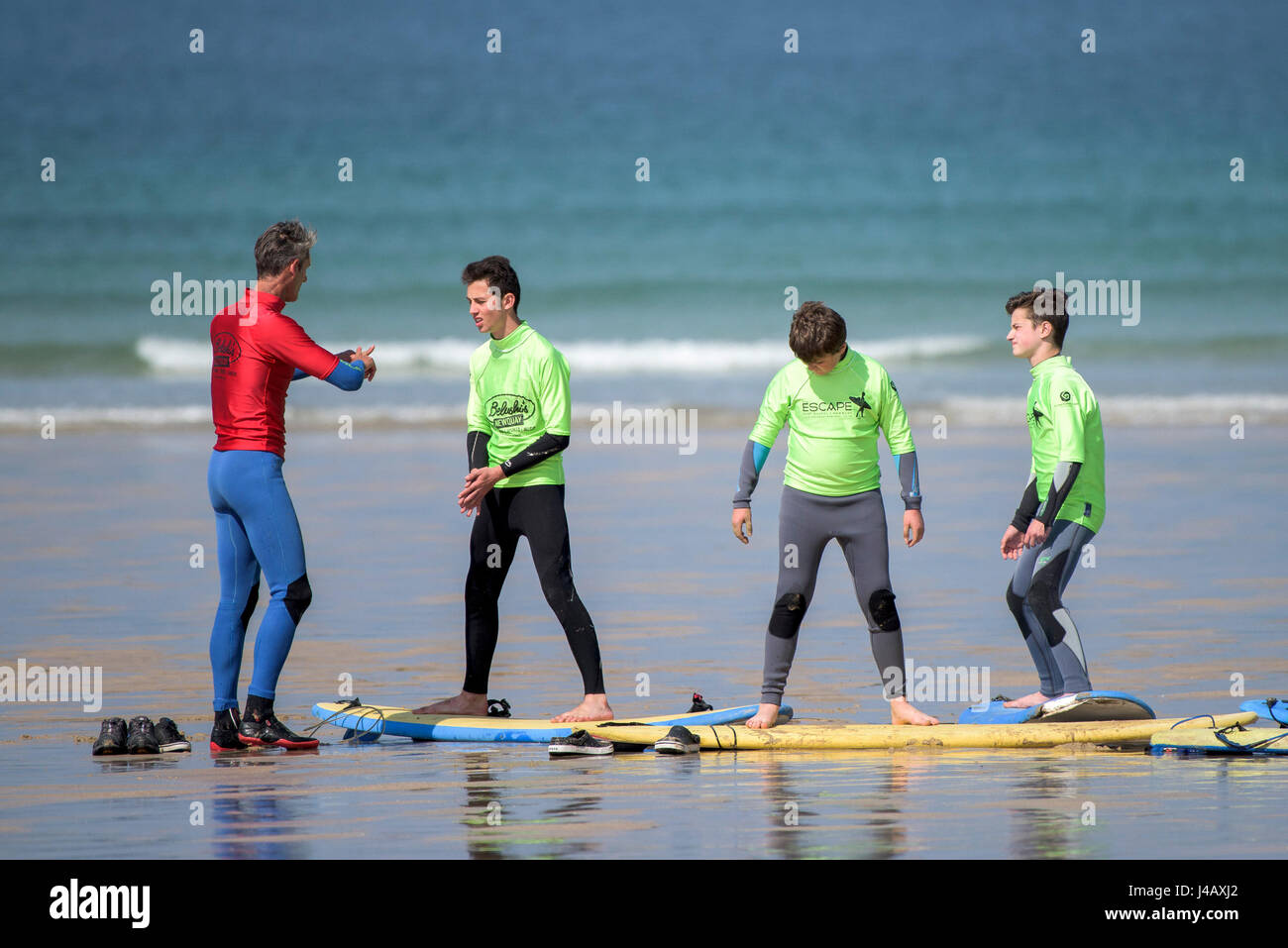 A surf school instructor teaching novices Newquay Cornwall Surfing ...