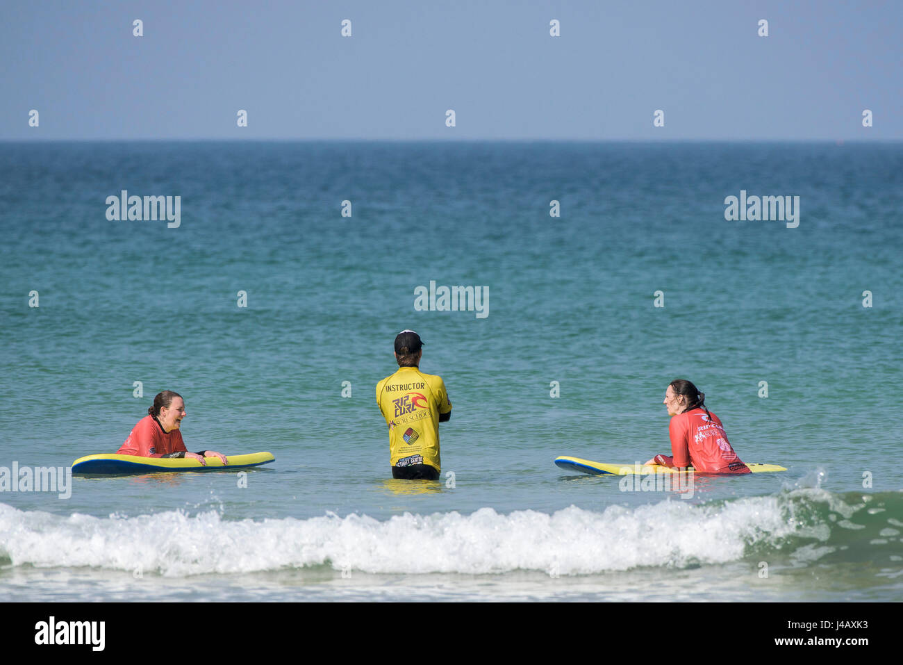 A surf school instructor teaching novices Fistral Beach Newquay ...