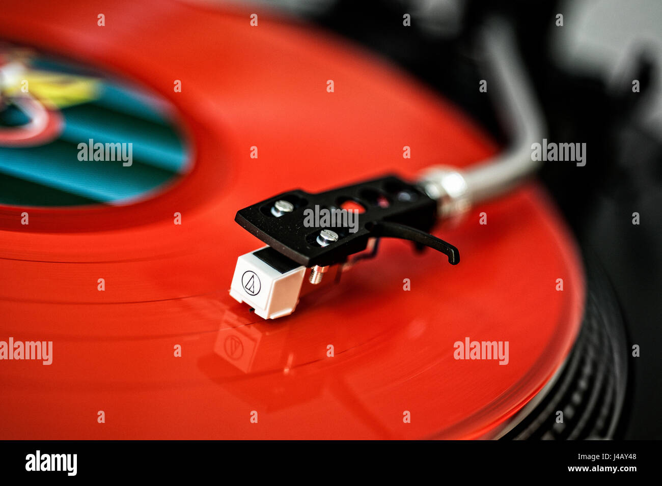 Pickup arm on red vinyl Stock Photo - Alamy