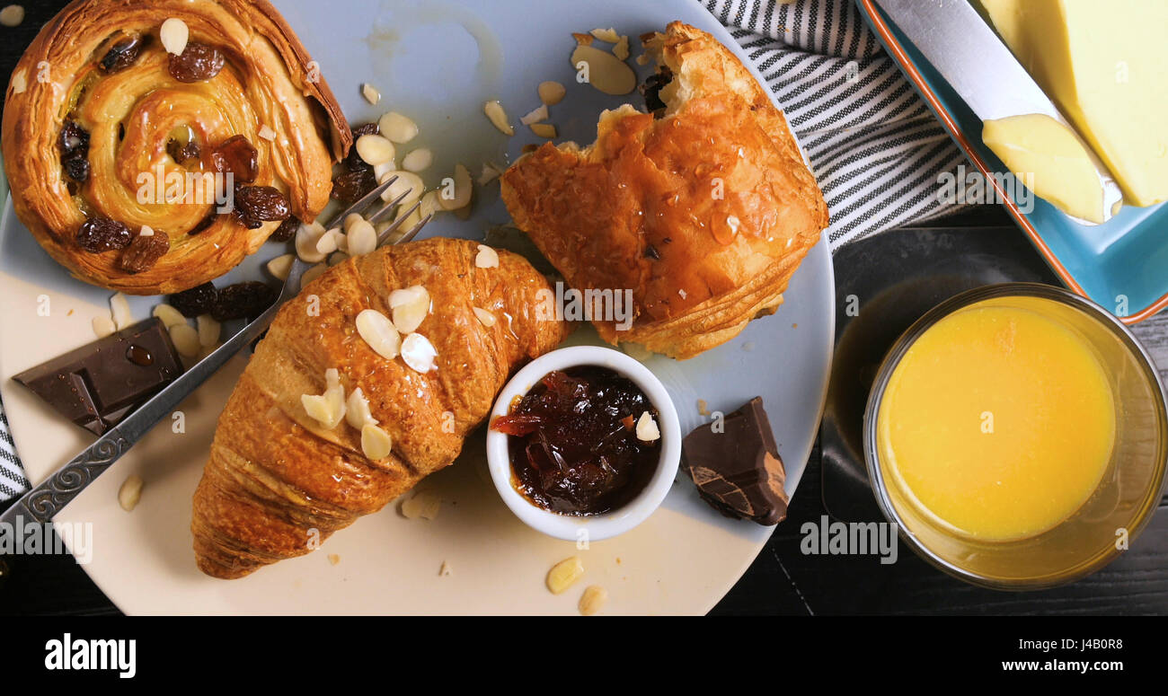 Top down view of a French breakfast with pastries, orange juice and ...