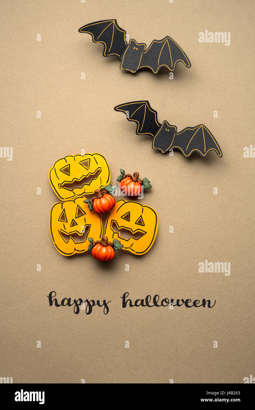 Creative halloween concept photo of pumpkins and bats made of paper on ...
