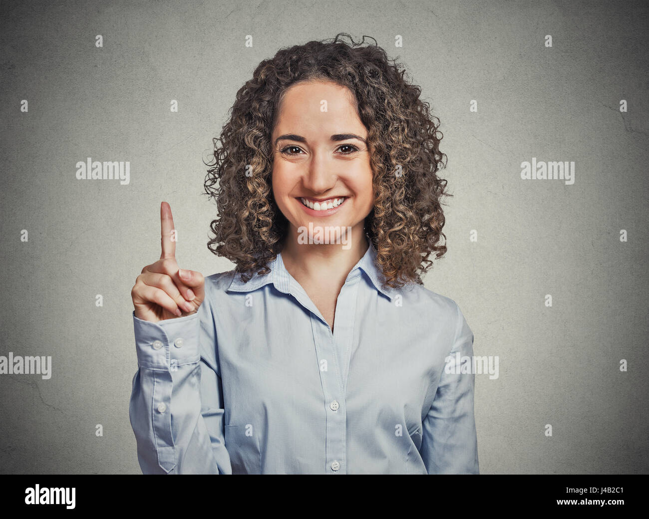 Number one. Closeup portrait young happy smiling woman student pointing ...