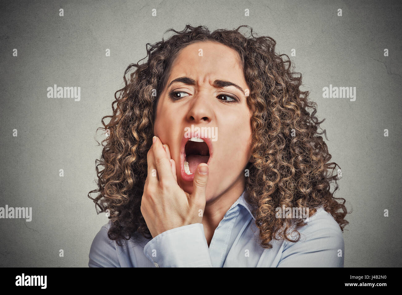 Closeup portrait young woman with sensitive tooth ache crown problem ...