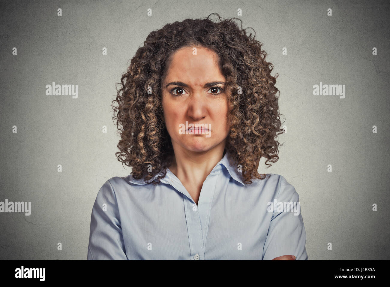 headshot angry woman isolated on grey wall background. Negative face ...