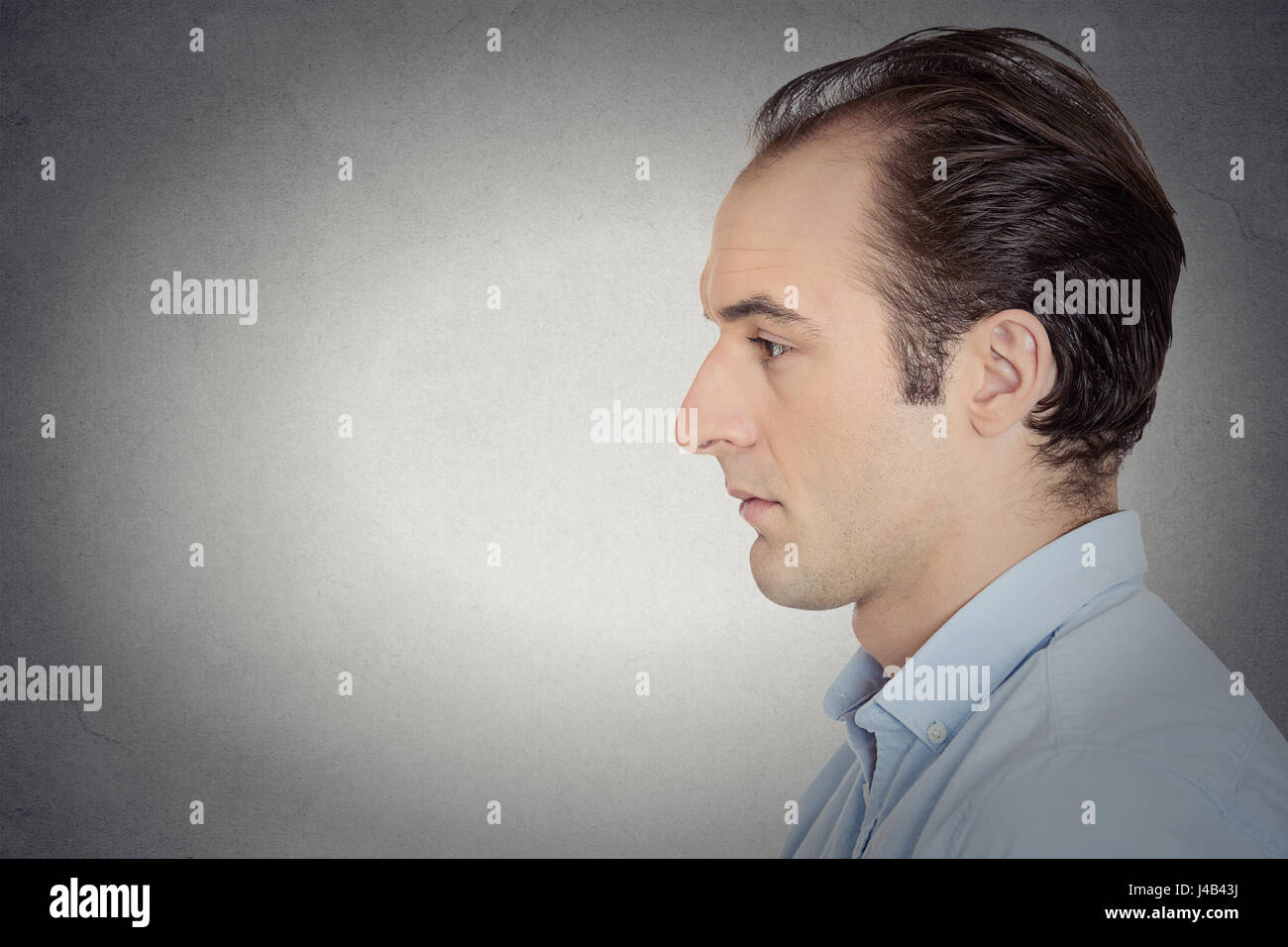 Closeup side view profile head shot portrait sad bothered stressed ...