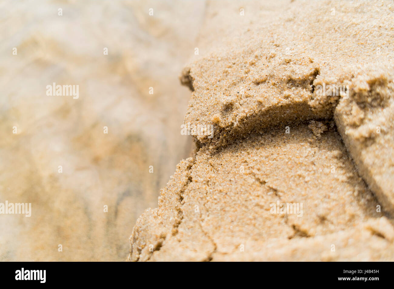 Beach sand with water background Stock Photo - Alamy