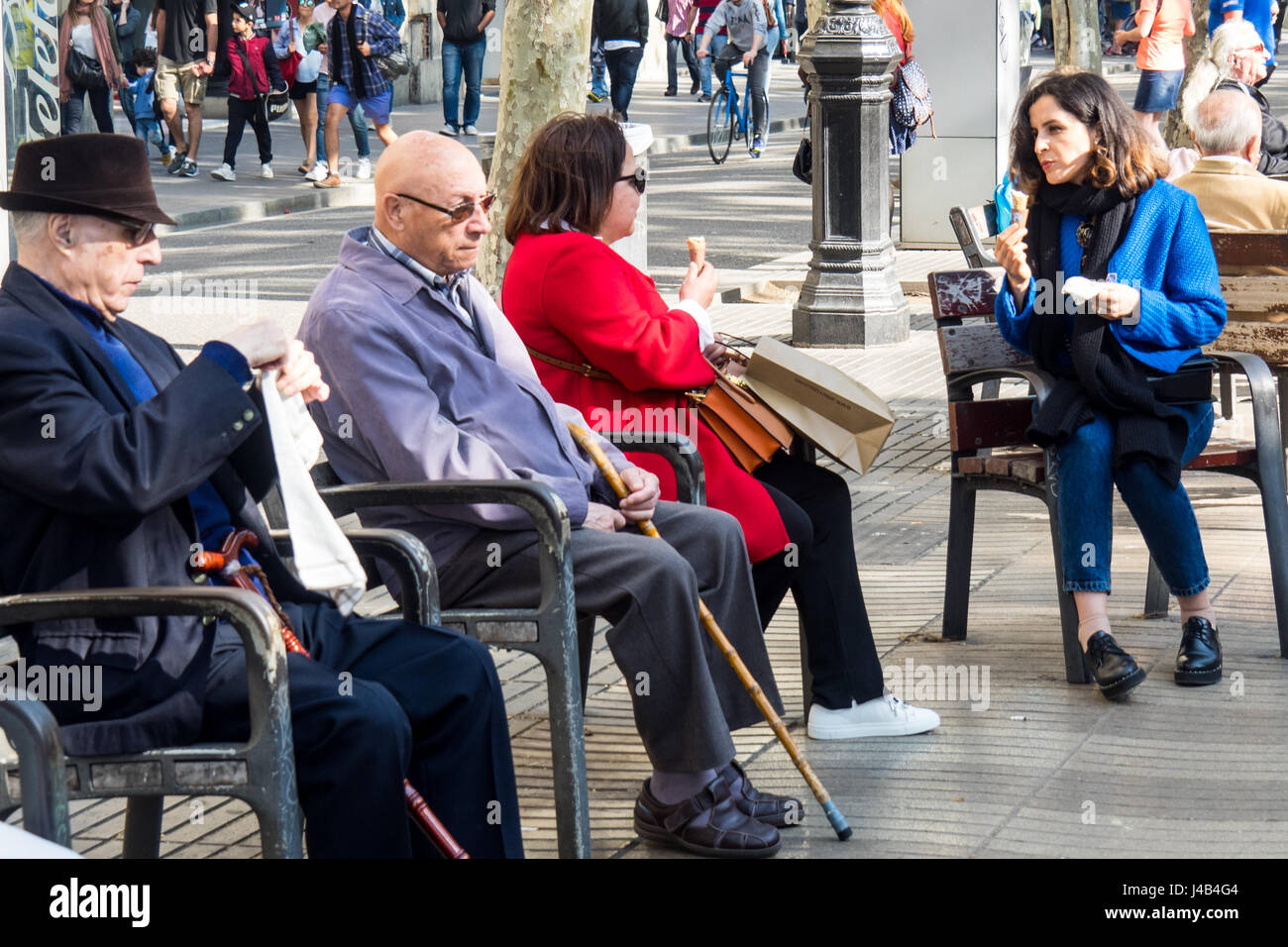 People sitting on public seating on La Rambla, Barcelona Spain Stock ...