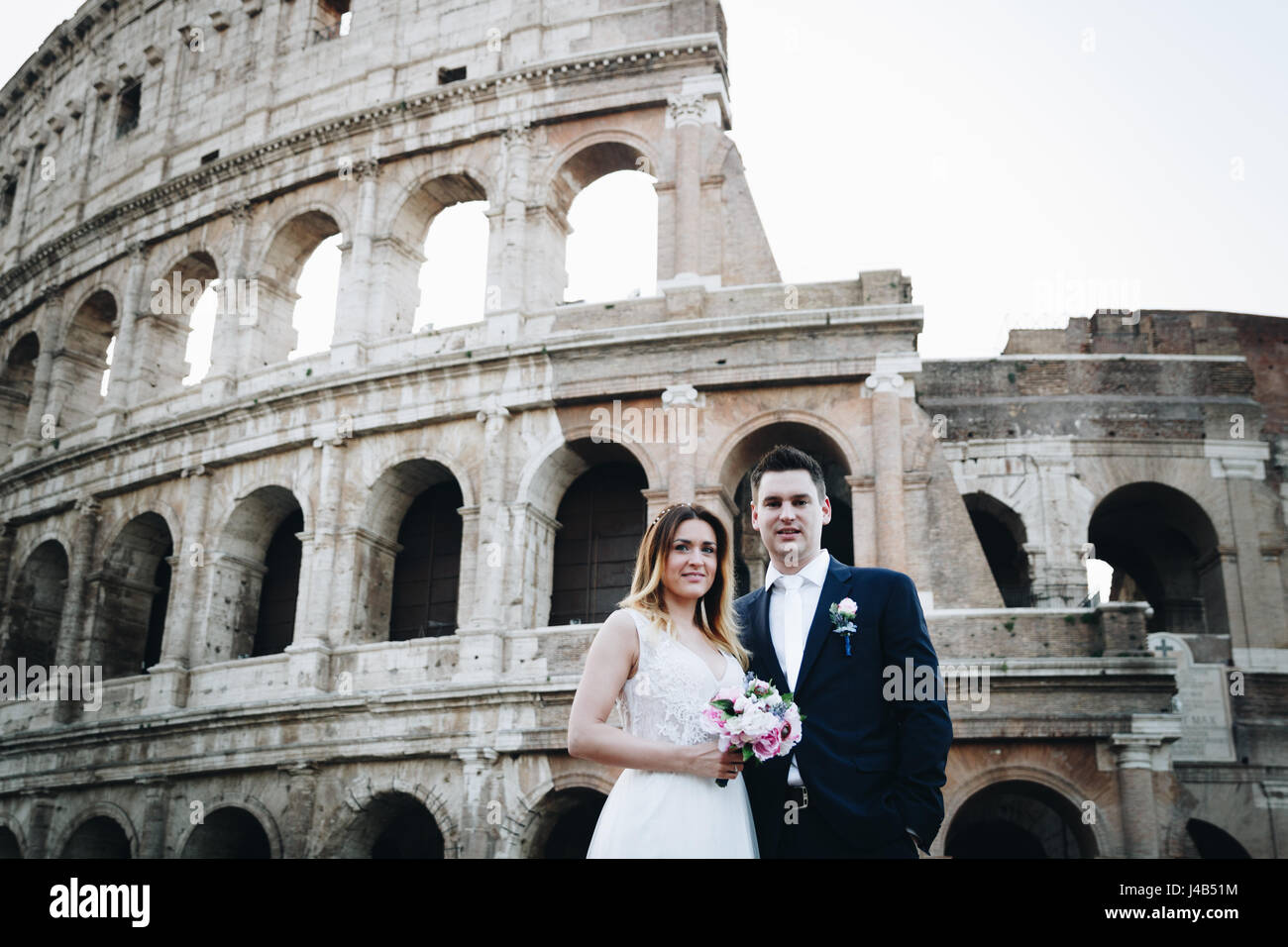 Bride and groom wedding poses in front of Colosseum, Rome, Italy Stock ...