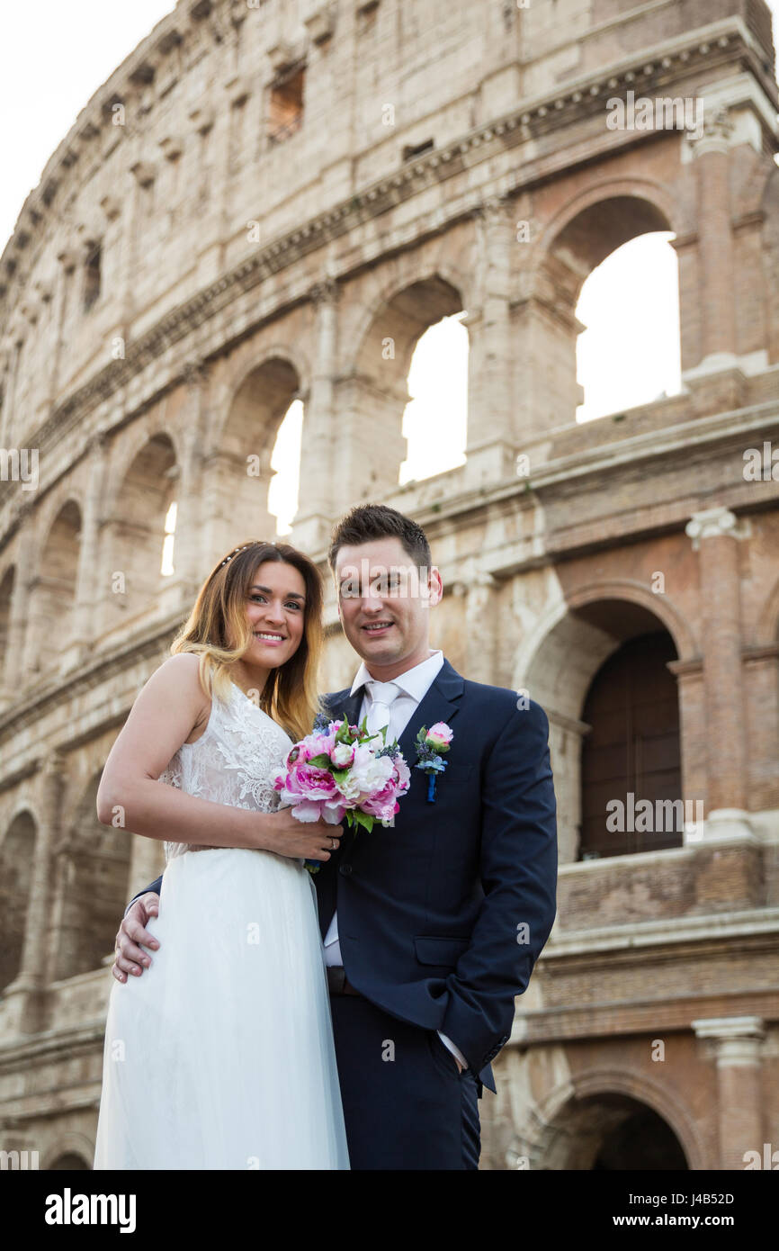 Bride and groom wedding poses in front of Colosseum, Rome, Italy Stock ...