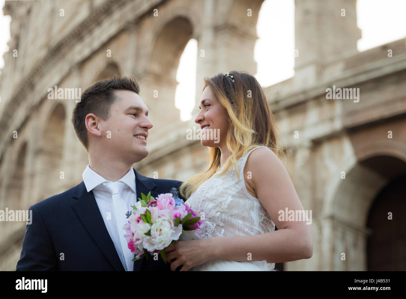 Bride and groom wedding poses in front of Colosseum, Rome, Italy Stock ...
