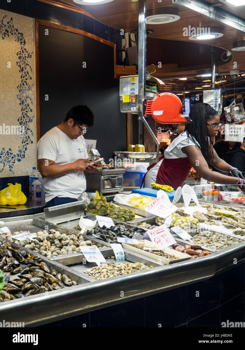 Female vendor behind counter hi-res stock photography and images - Alamy