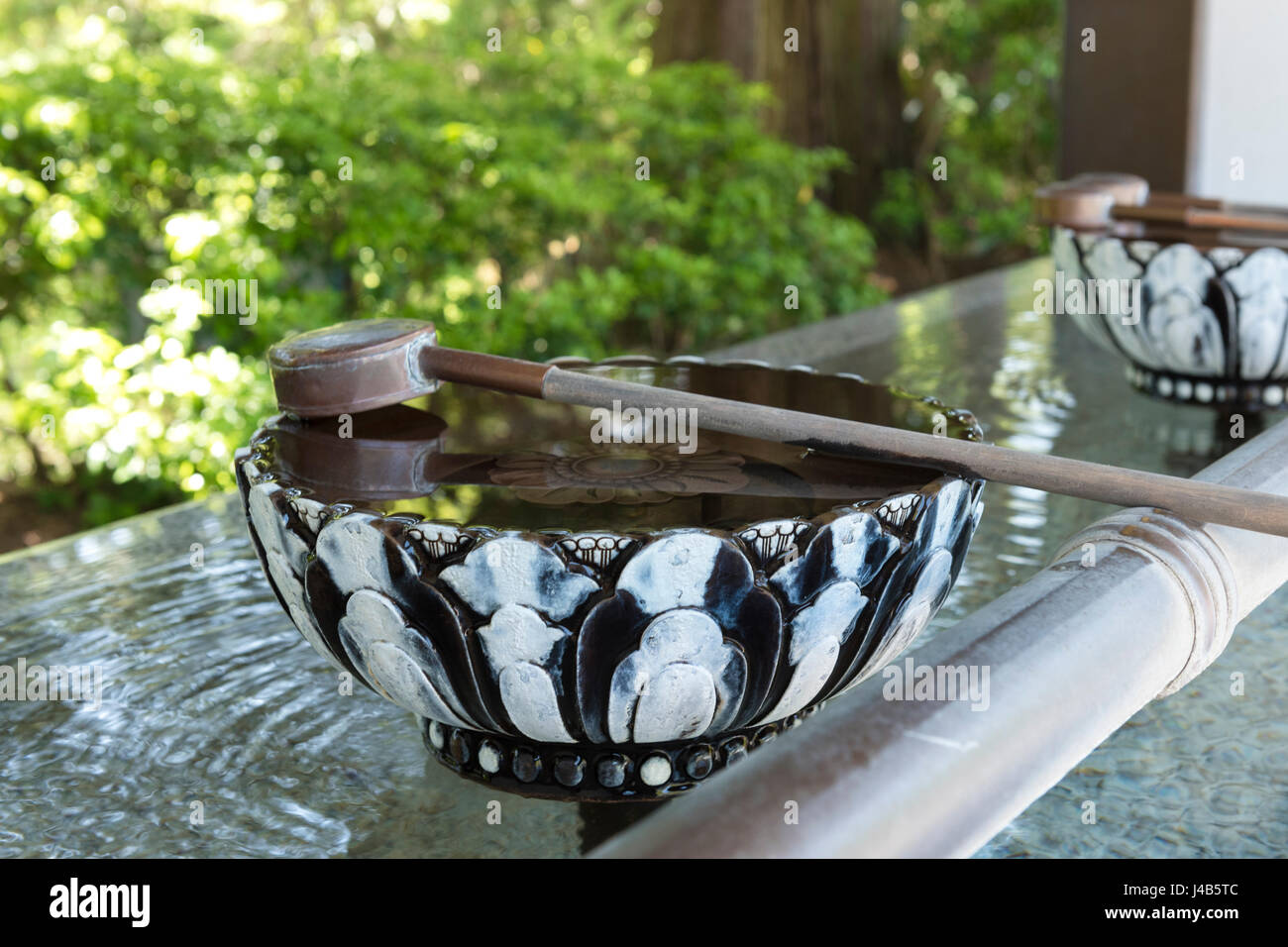 Traditional cleansing bowl and cup for visitors to carry out ritual ...