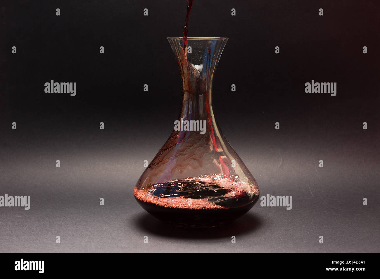 Decanting red wine Stock Photo - Alamy