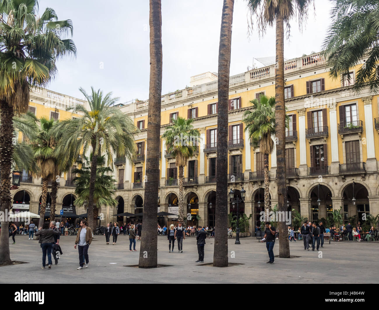 Tourists enjoying al fresco dining in Placa Reial , Barcelona, Spain ...