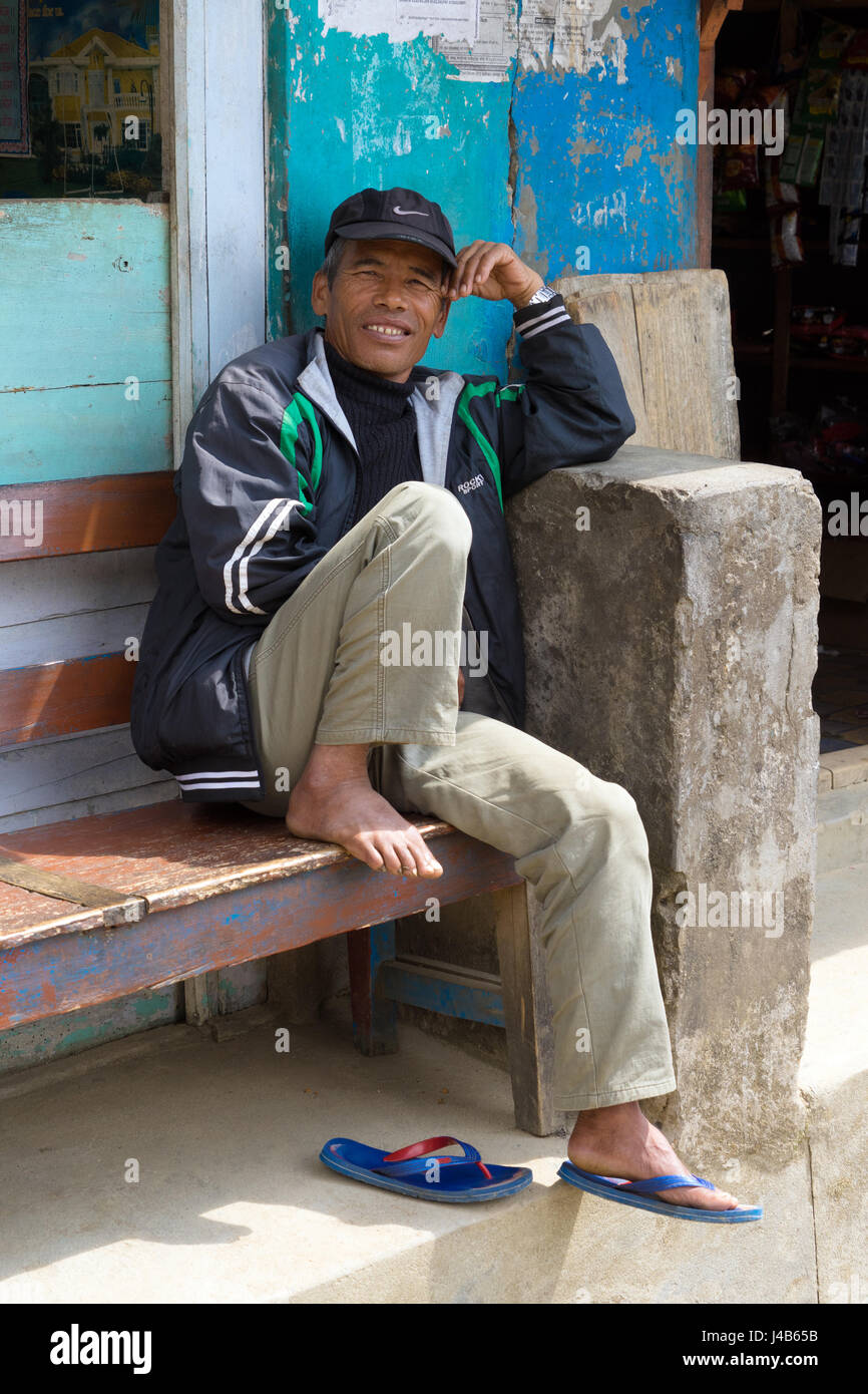 Nepalese man sitting on a bench, Bahundanda, Annapurna region Stock ...