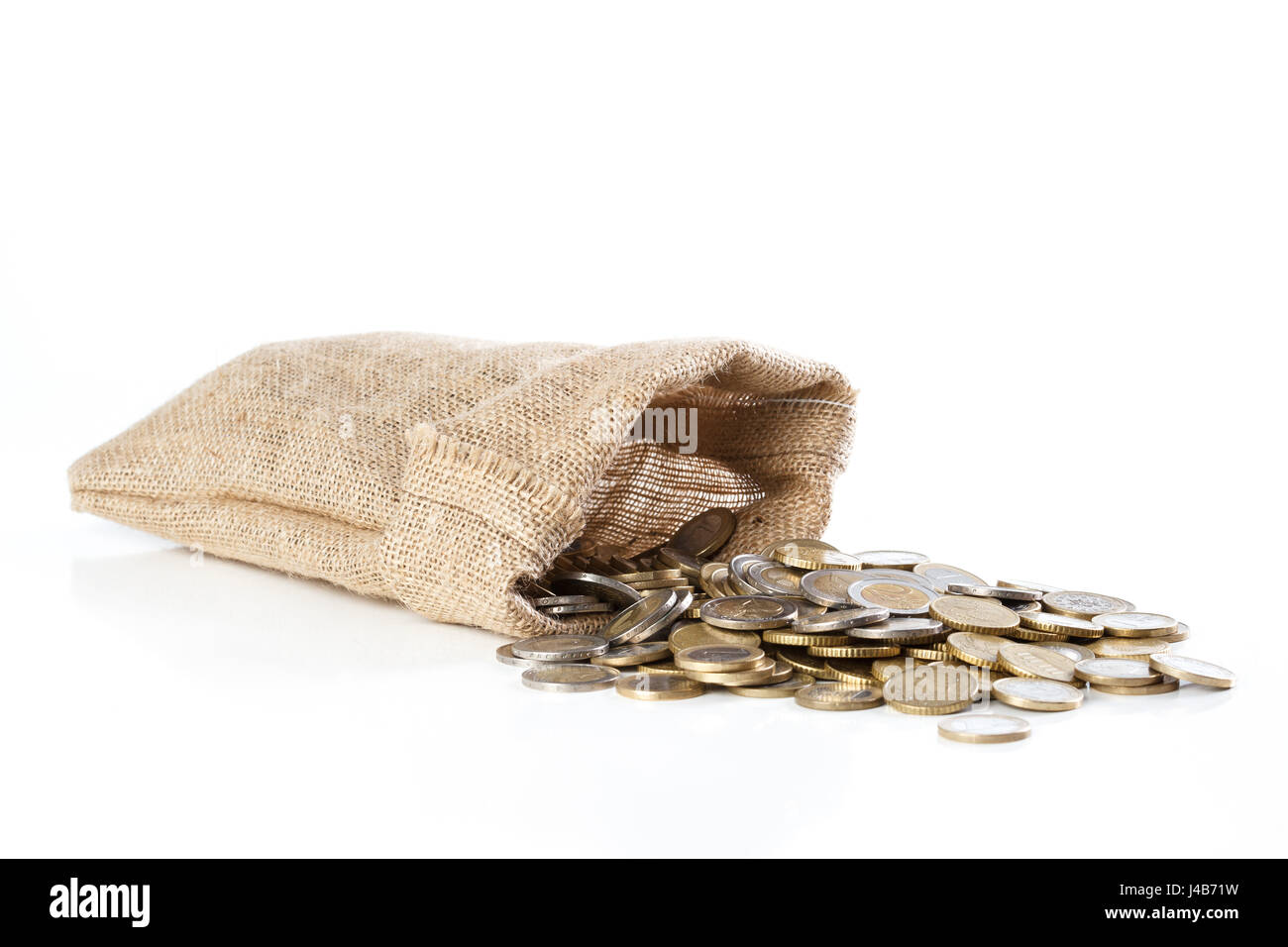 Coins falling out of a small burlap sack, on white isolated background ...