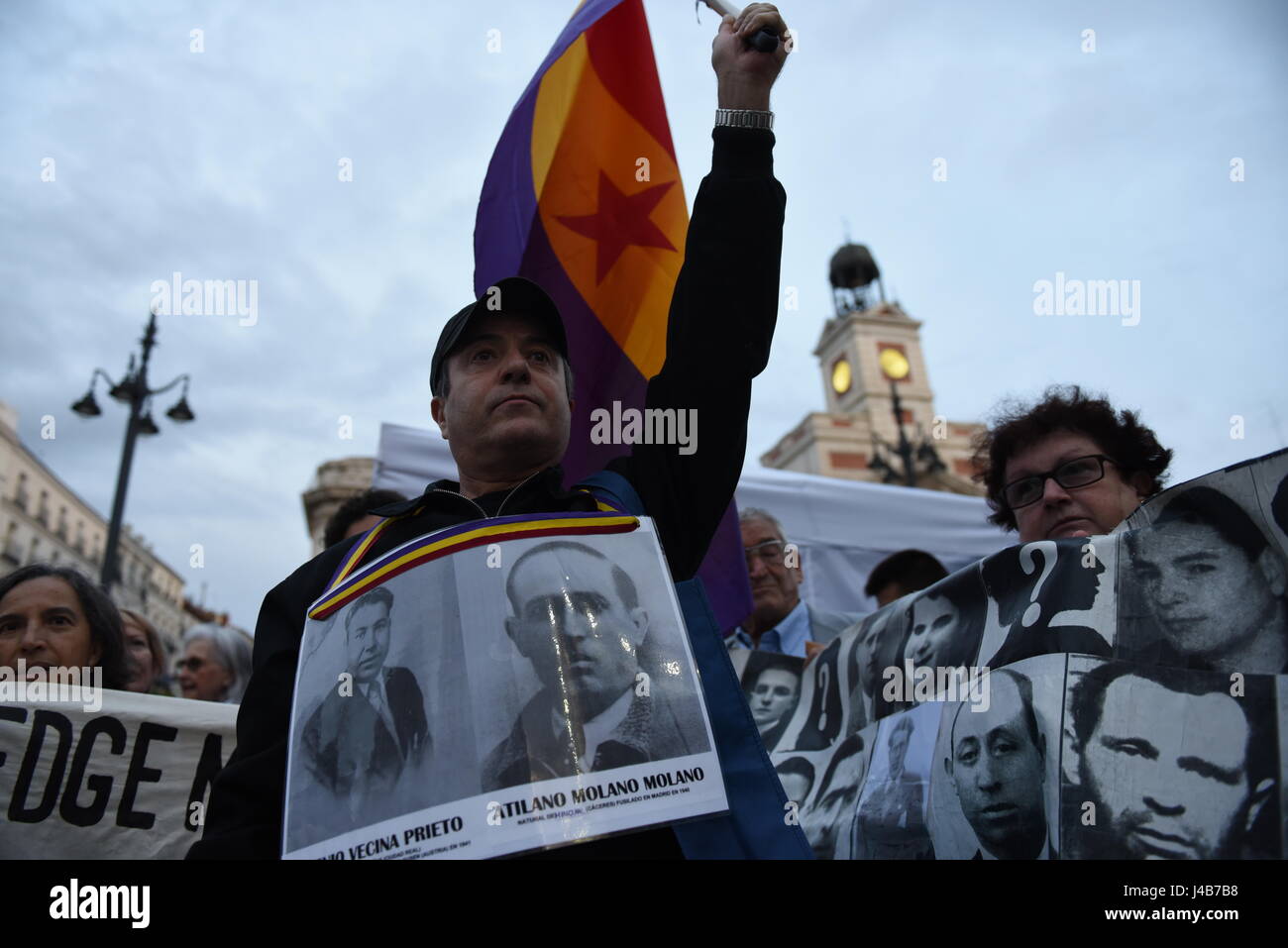A woman holds pictures of relatives, missing during the Spanish ...