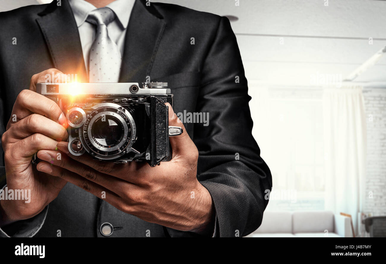 Man with camera in hands Stock Photo - Alamy