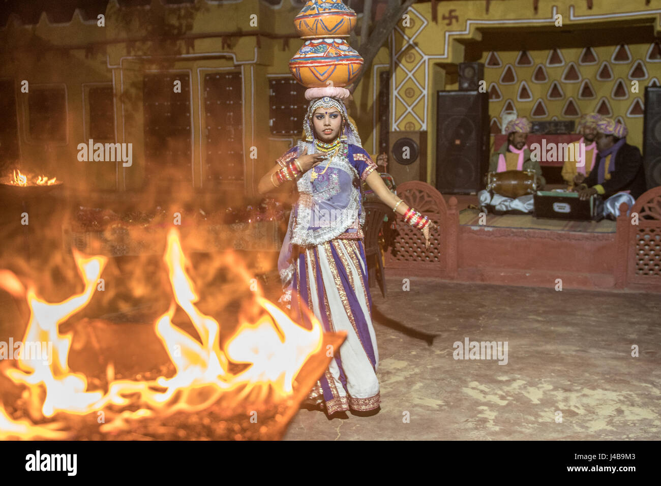 Indian woman dancing with pot on her head Stock Photo - Alamy