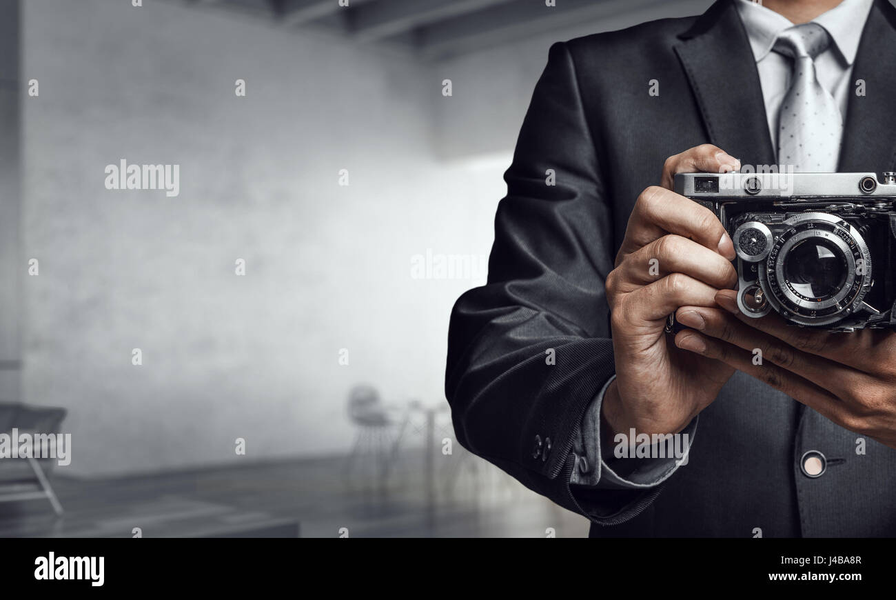 Man with camera in hands Stock Photo - Alamy