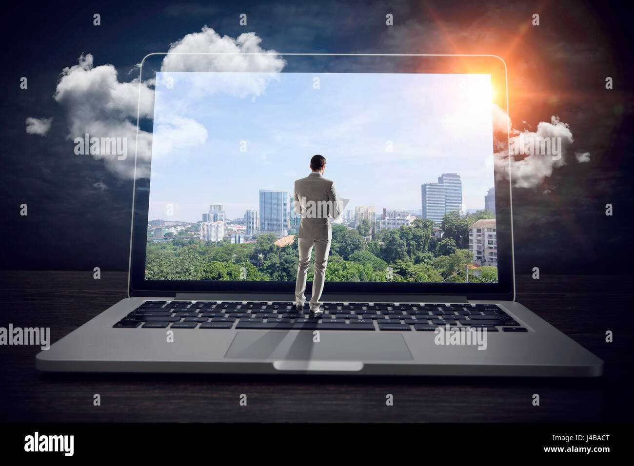 Man on huge laptop Stock Photo - Alamy