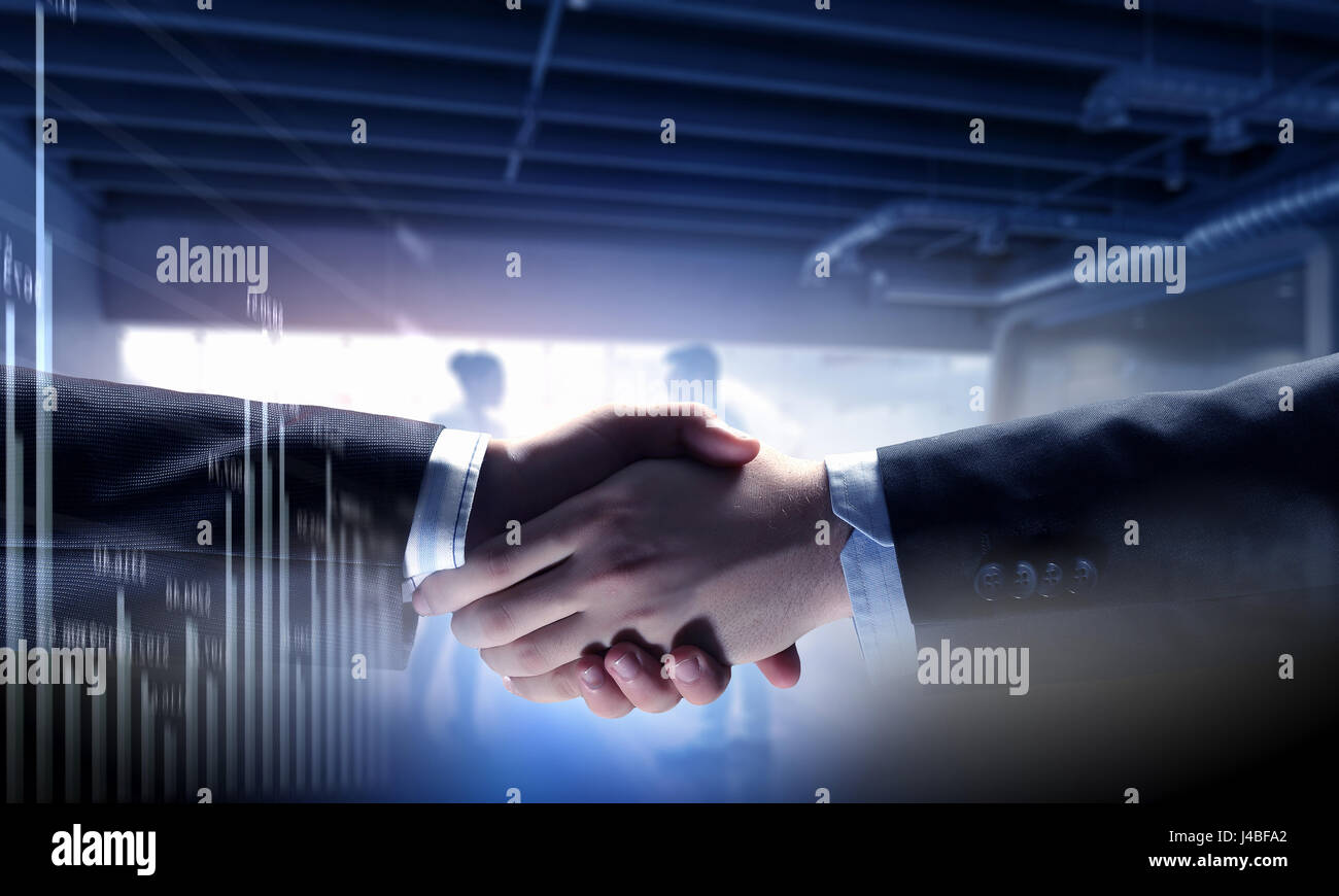 Partners shaking hands as symbol of deal Stock Photo - Alamy