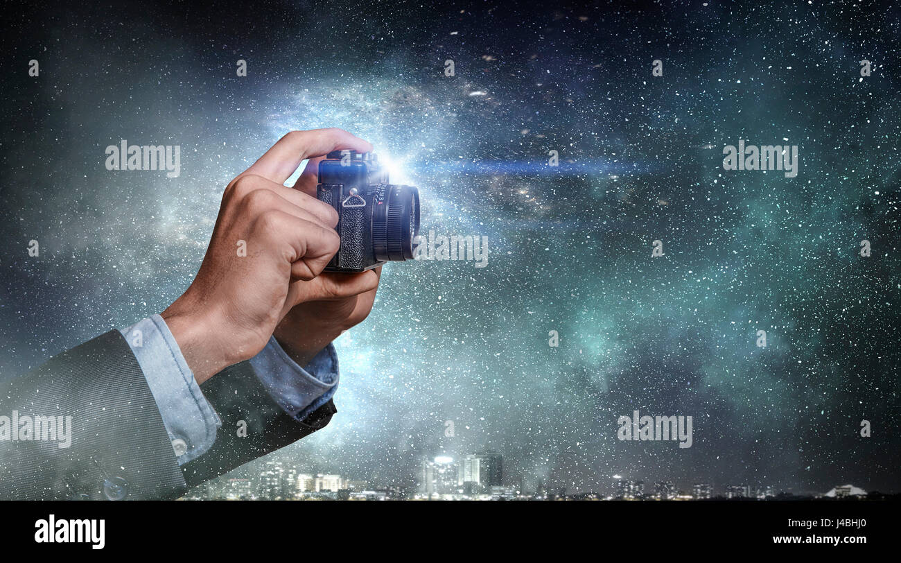 Man with camera in hands Stock Photo - Alamy