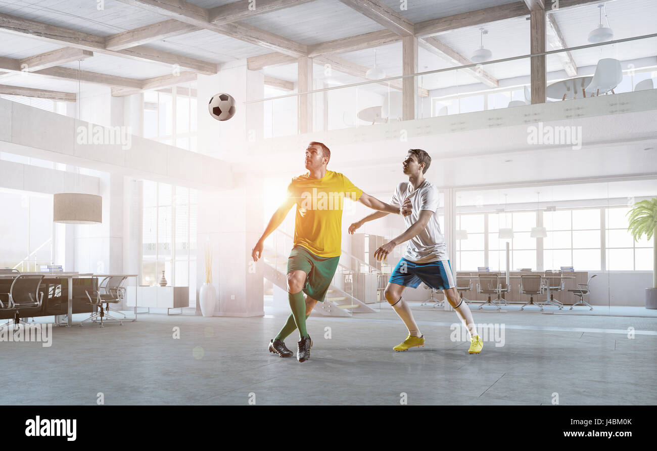 Playing football in office Stock Photo - Alamy