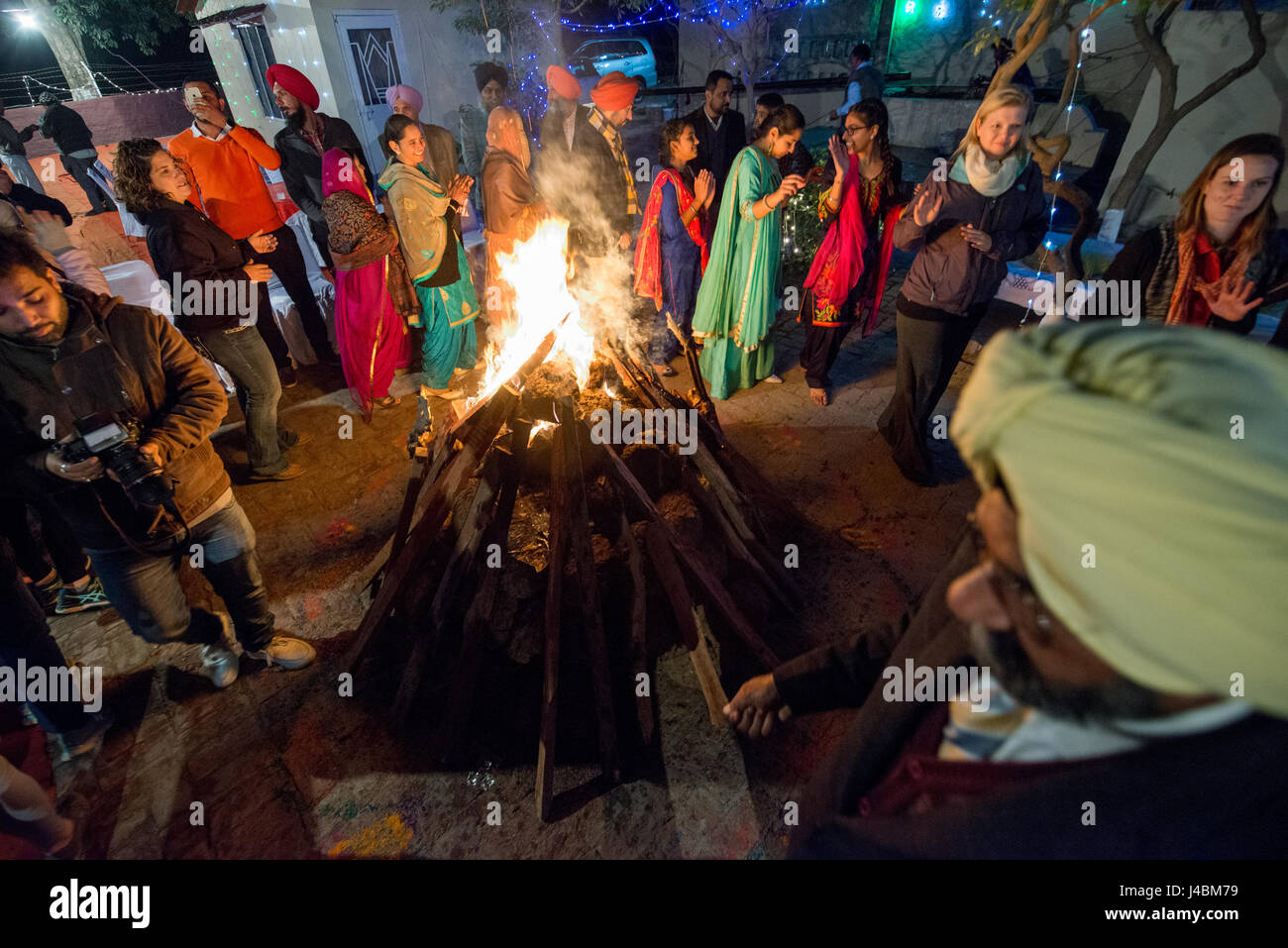 Guests dance, sing, and clap around the bonfire at the Lohri ...