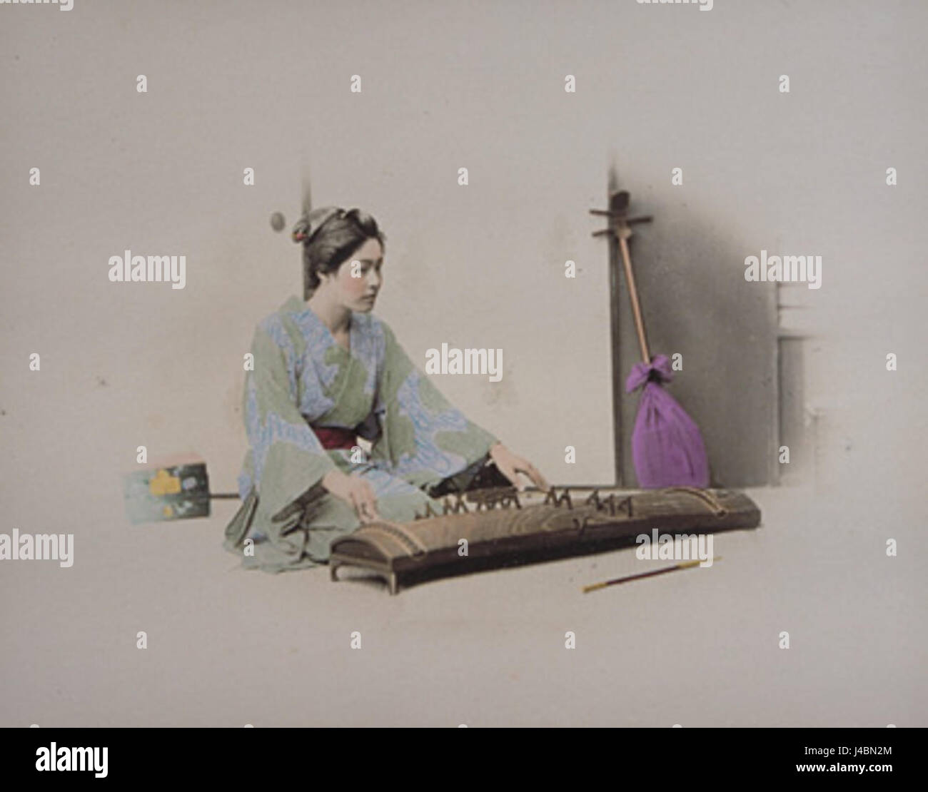 A photograph by Raimund von Stillfried, featuring a woman playing the ...