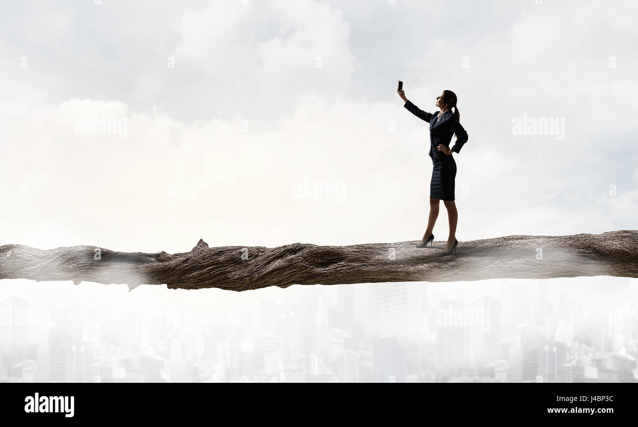 Businesswoman catching moment on her mobile Stock Photo - Alamy