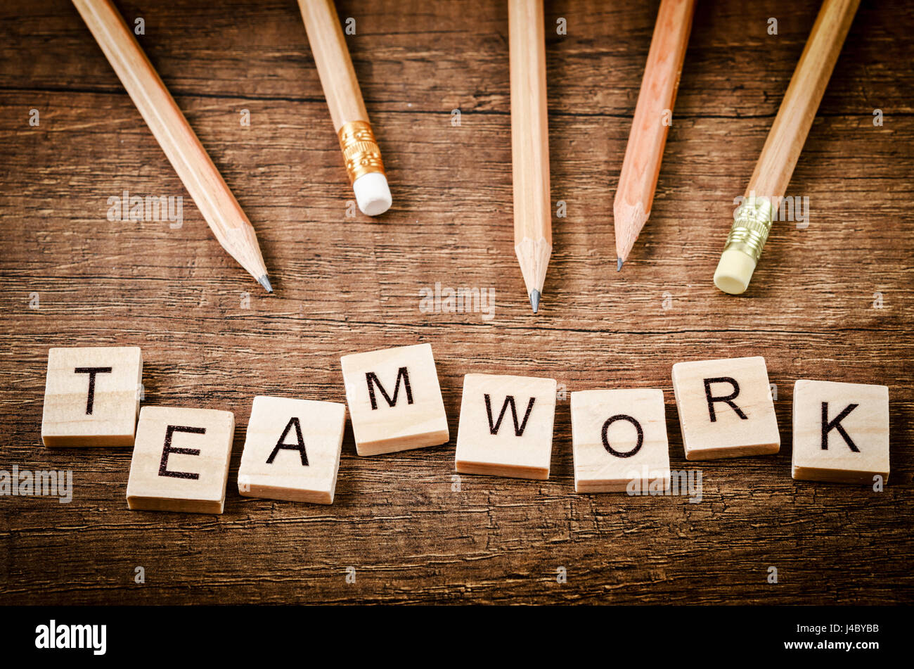 TEAMWORK word written on wood block with wood pencils on wooden ...