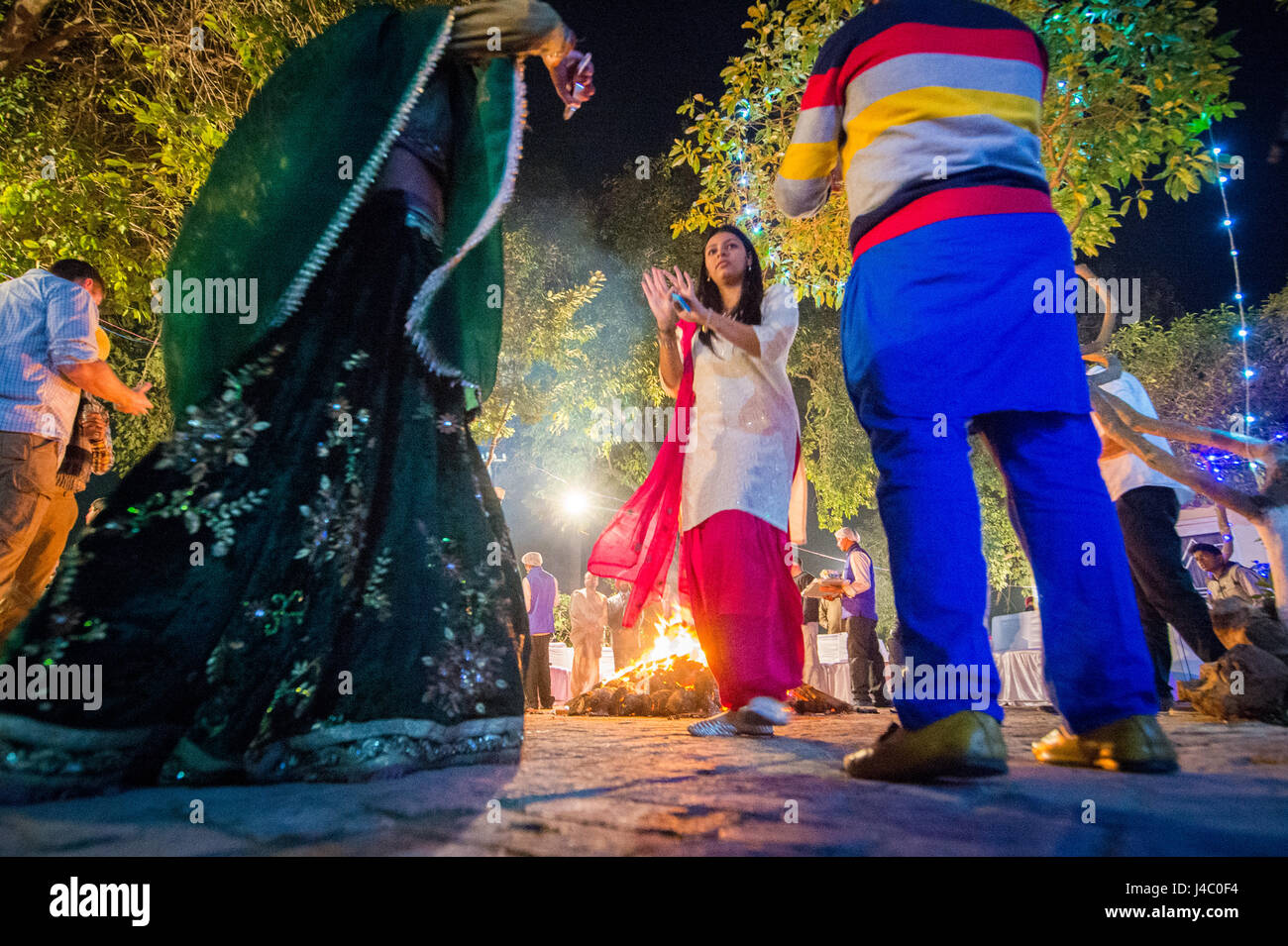 People dancing around the bonfire at the Lohri celebration in Punjab ...