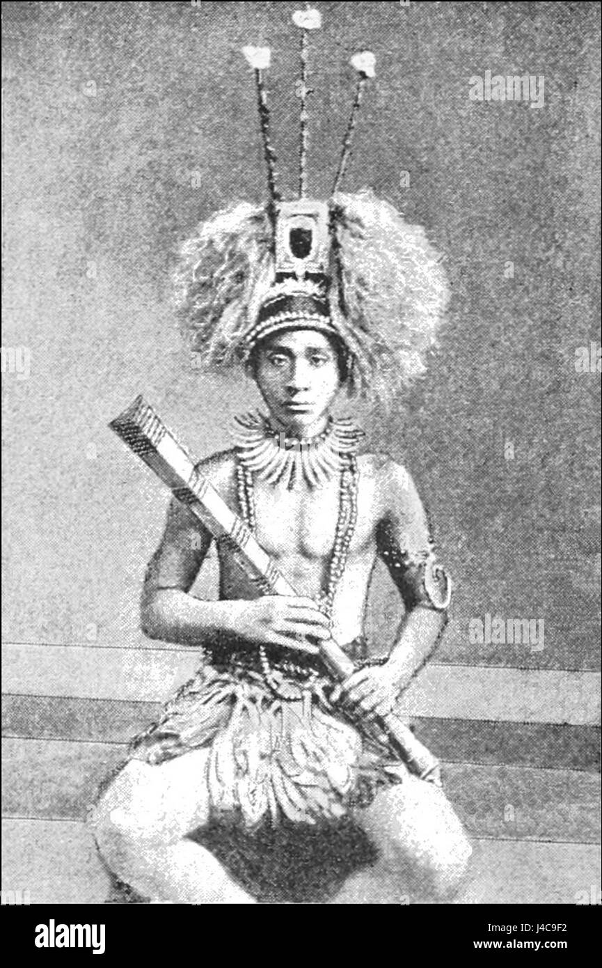The image shows a Samoan chief adorned with traditional ornaments ...