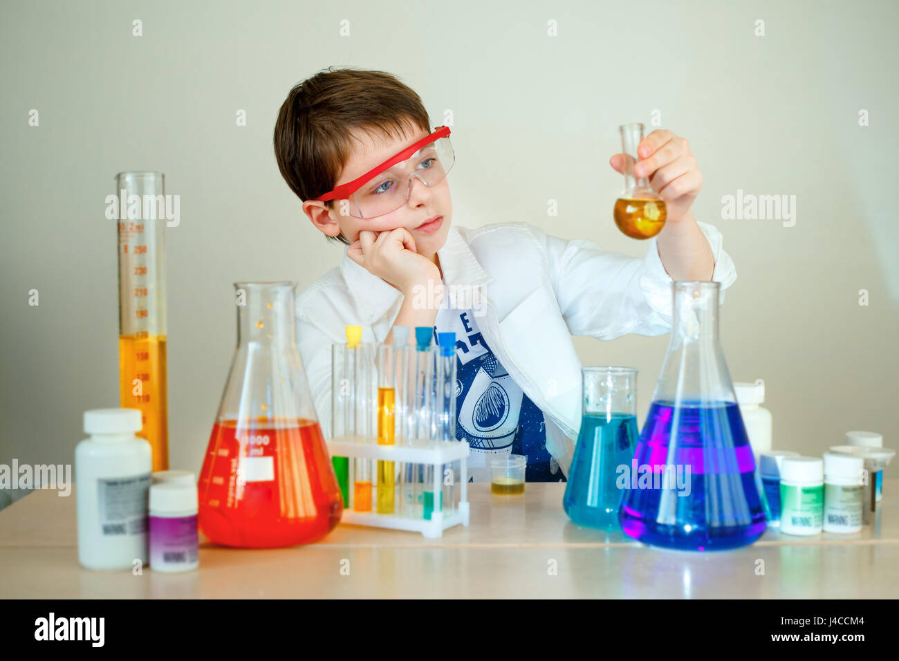 Cute boy is making science experiments in a laboratory. Education Stock ...
