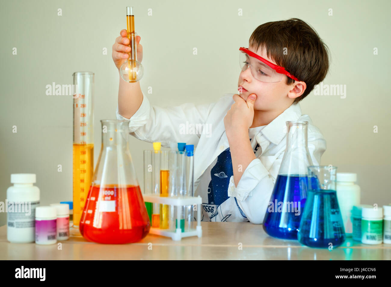 Cute boy is making science experiments in a laboratory. Education Stock ...