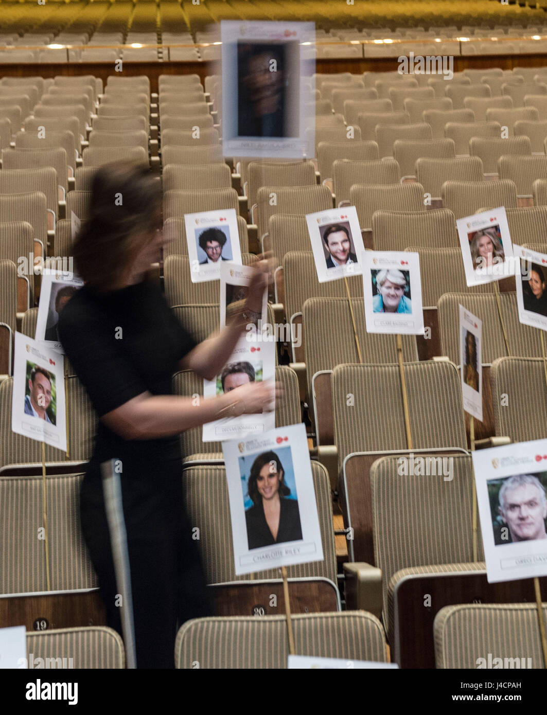 A staff member uses heads on sticks to check camera blocking for the ...