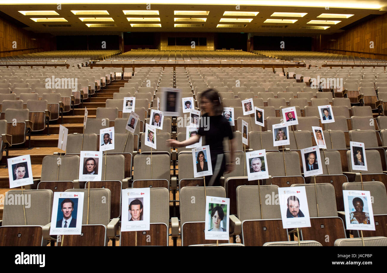 A staff member uses "heads on sticks" to check camera blocking for the ...